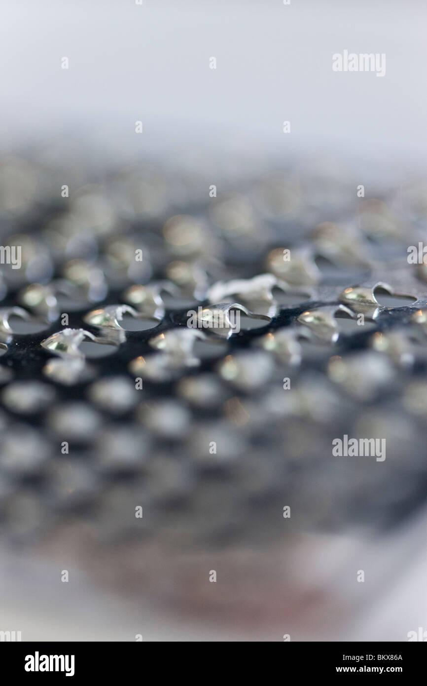 Extreme close up of a cheese grater Stock Photo - Alamy