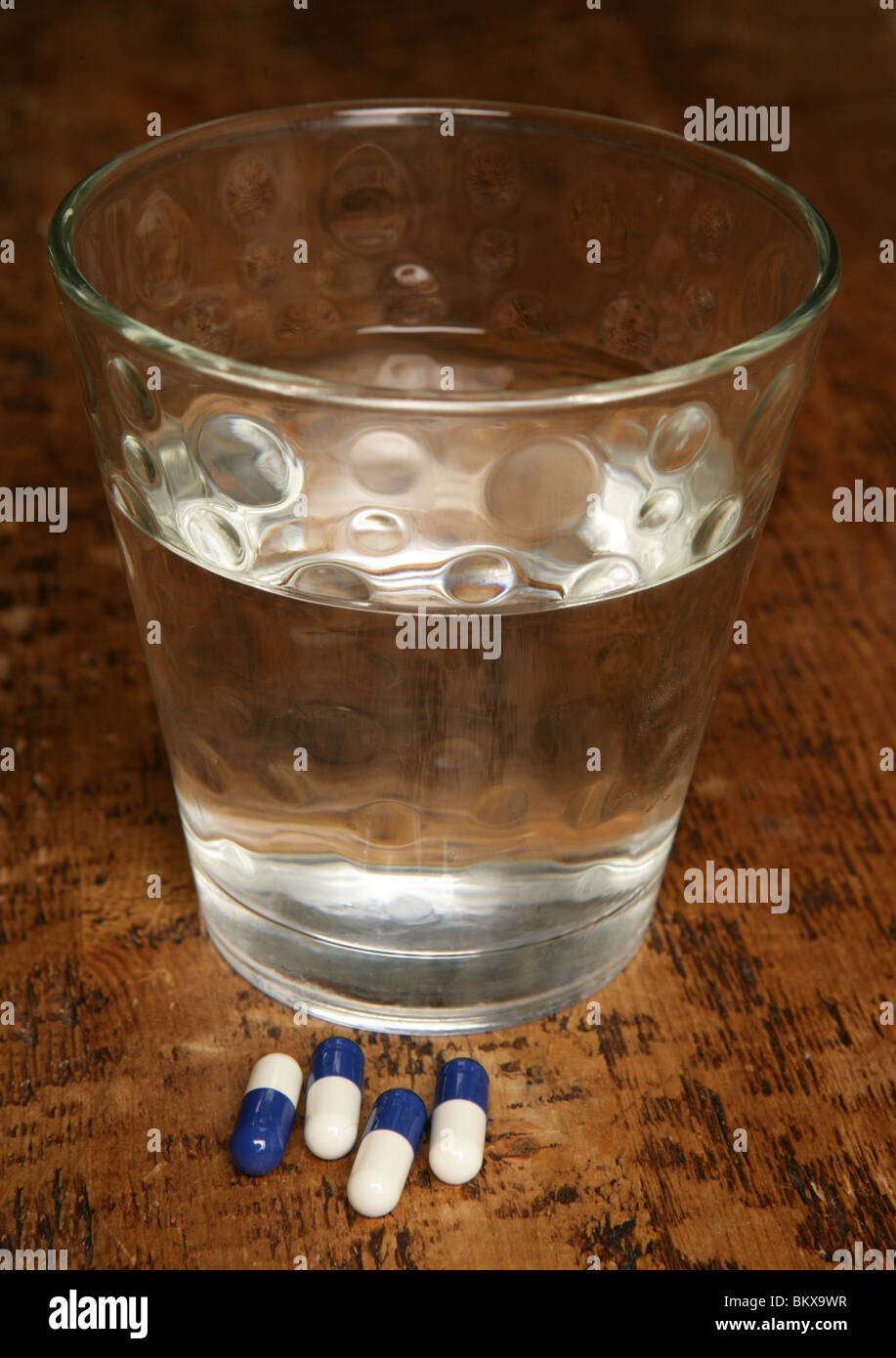 Glass of water and medication studio portrait Stock Photo - Alamy