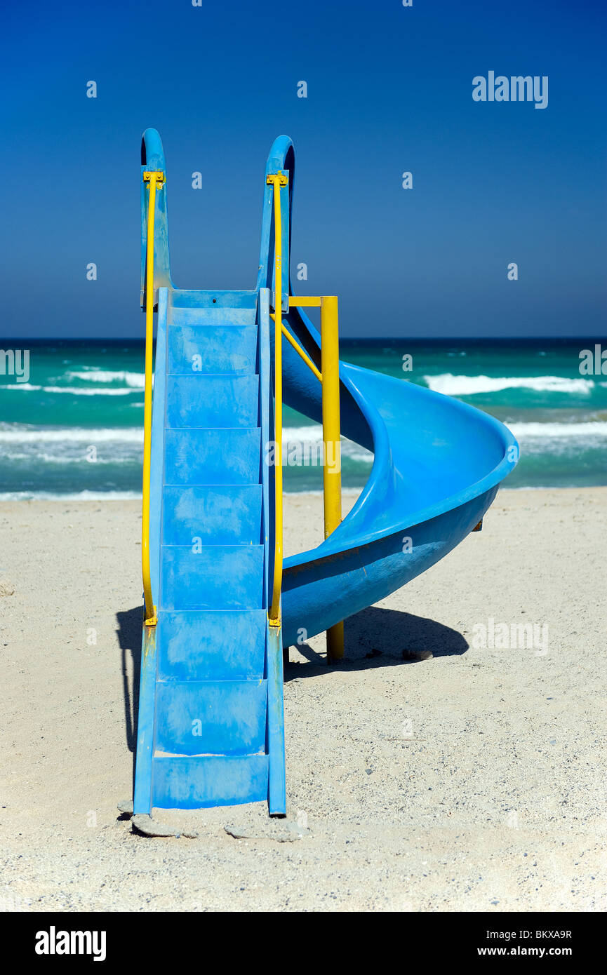 Playground slide on the beach in Oman Stock Photo - Alamy