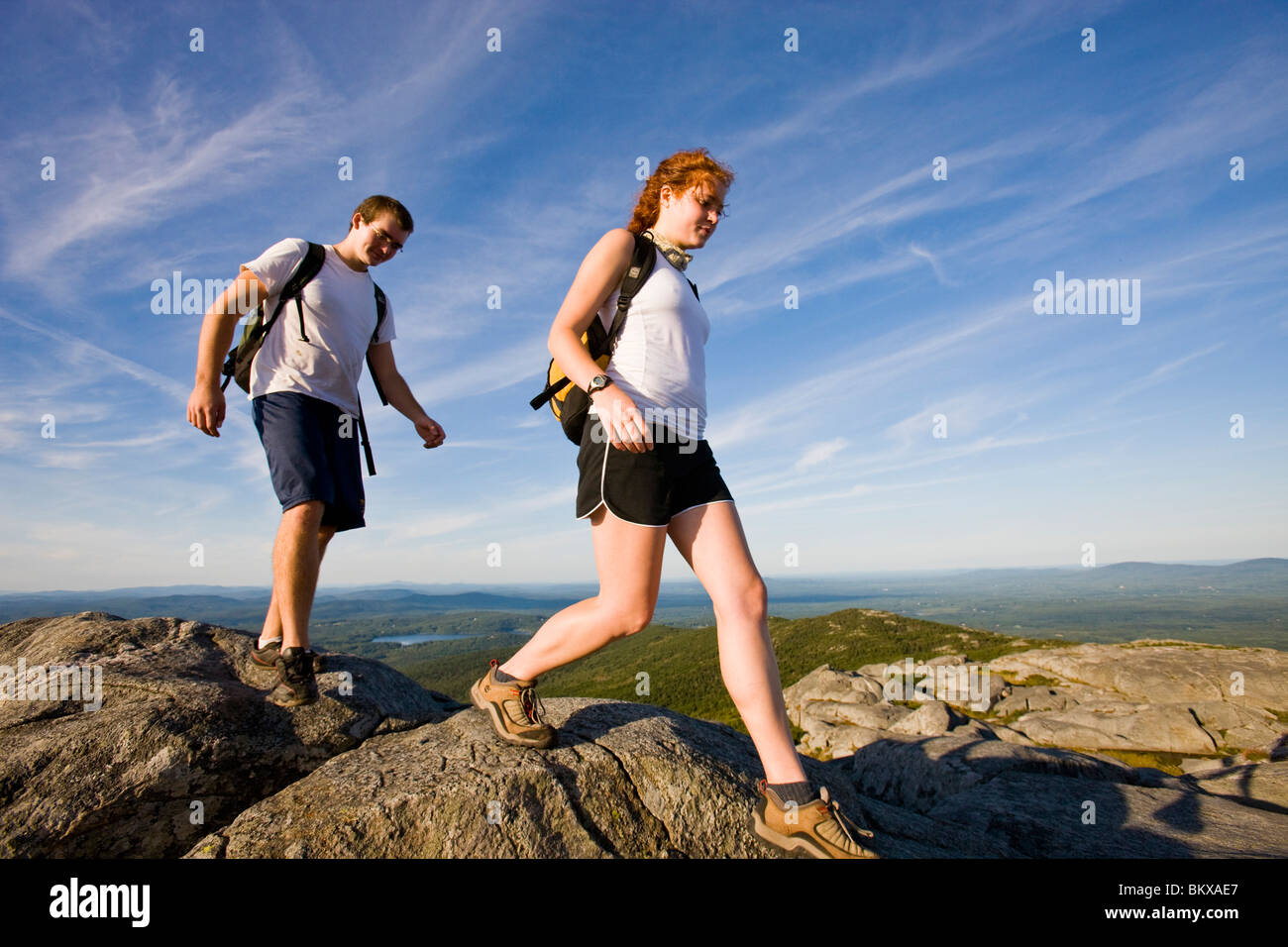 A young couple hiking on the summit of Mount Monadnock in New Hampshire ...