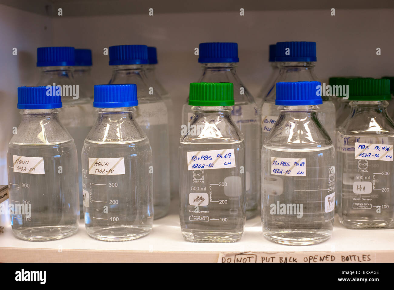 Heat-proof pyrex glass bottles with a colorless transparent liquid ...