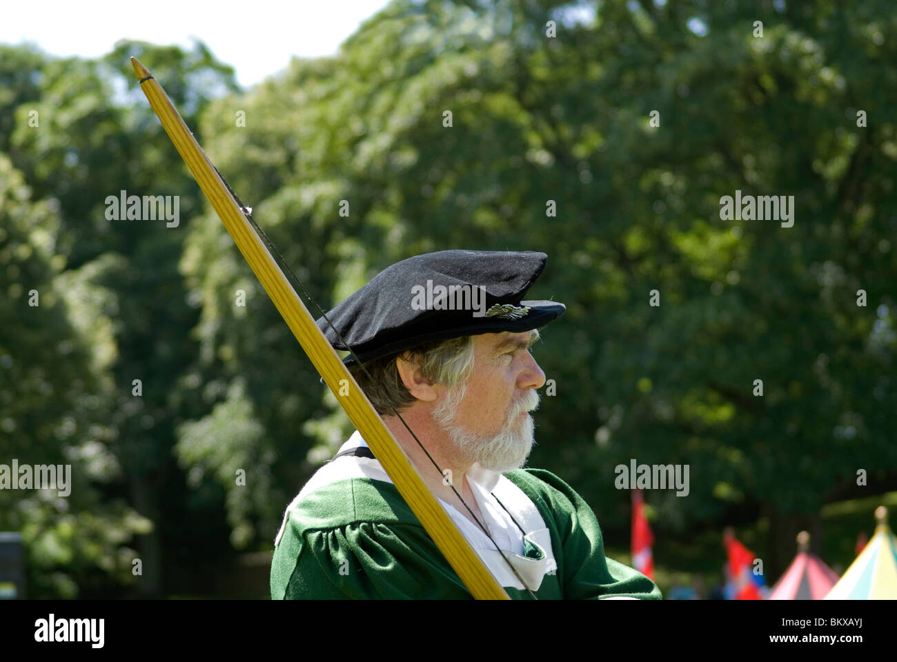 The head and shoulders of a man in medieval costume carrying a bow ...