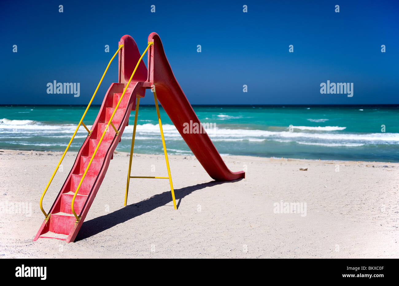 Playground slide on the beach in Oman Stock Photo - Alamy