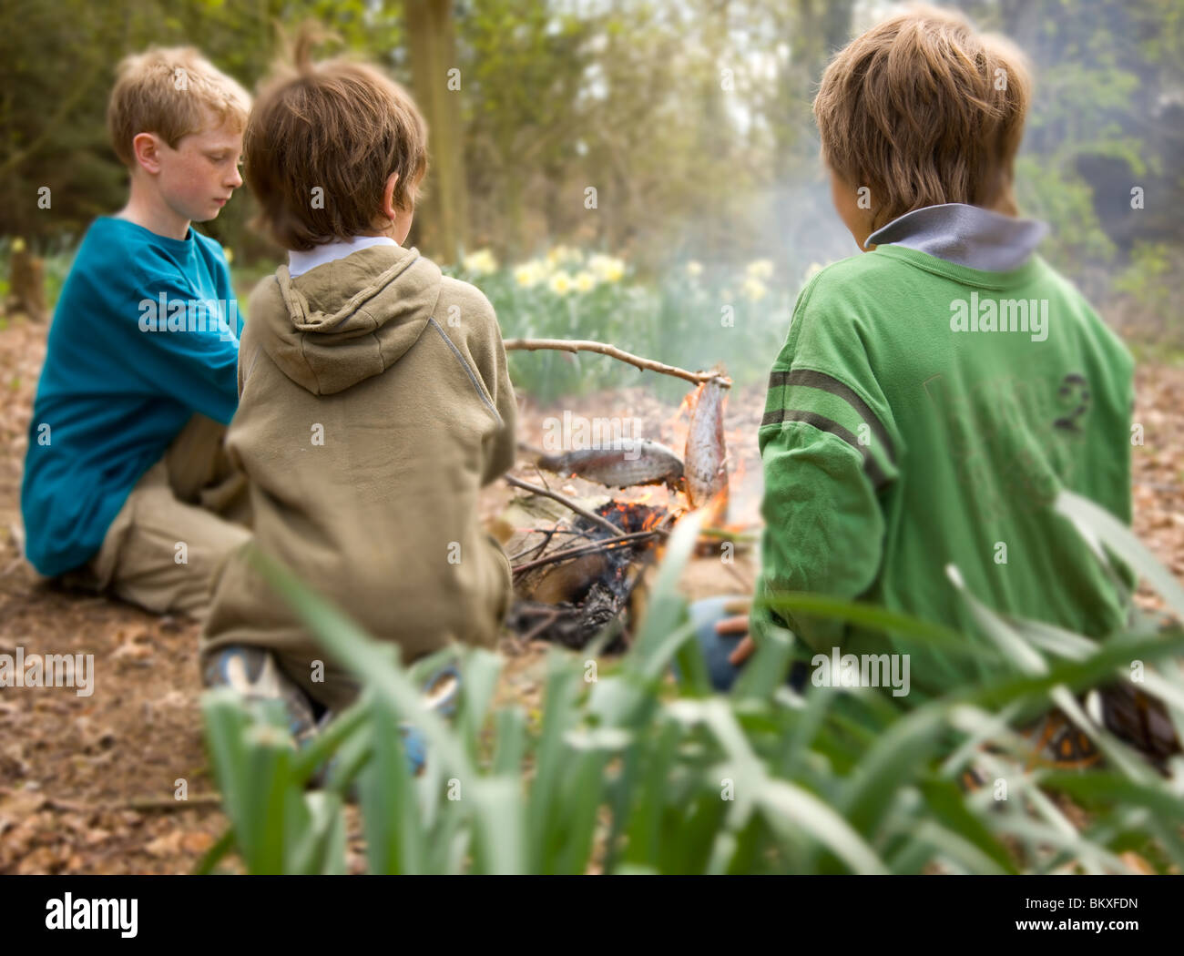 Three People Sitting Around Campfire High Resolution Stock Photography ...