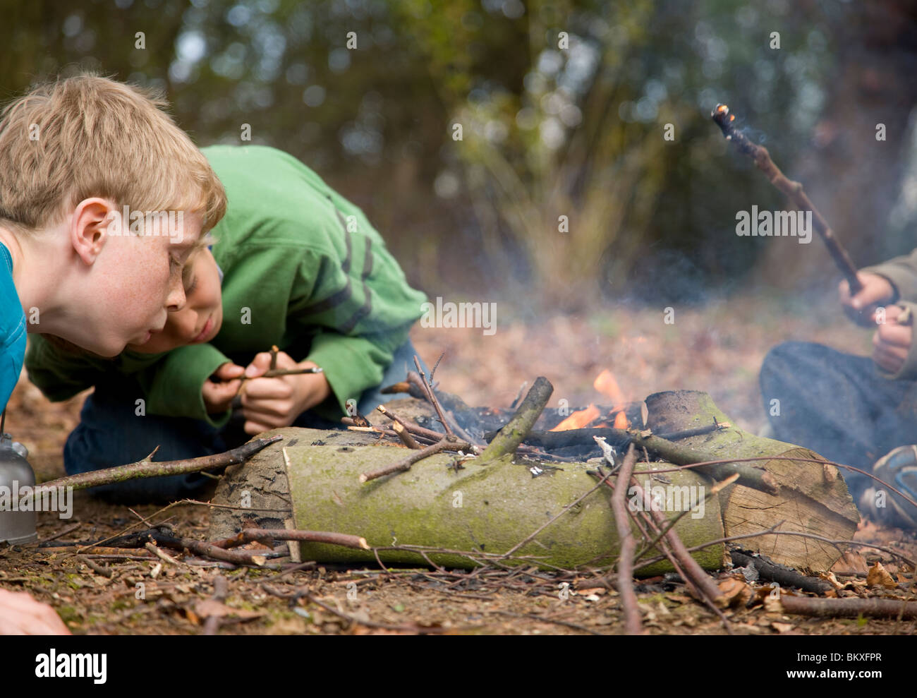 Three People Sitting Around Campfire High Resolution Stock Photography ...