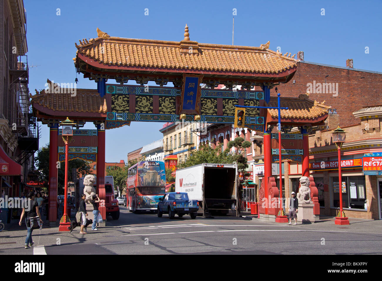 Colourful gate to entrance of Chinatown with marble lions at the base ...
