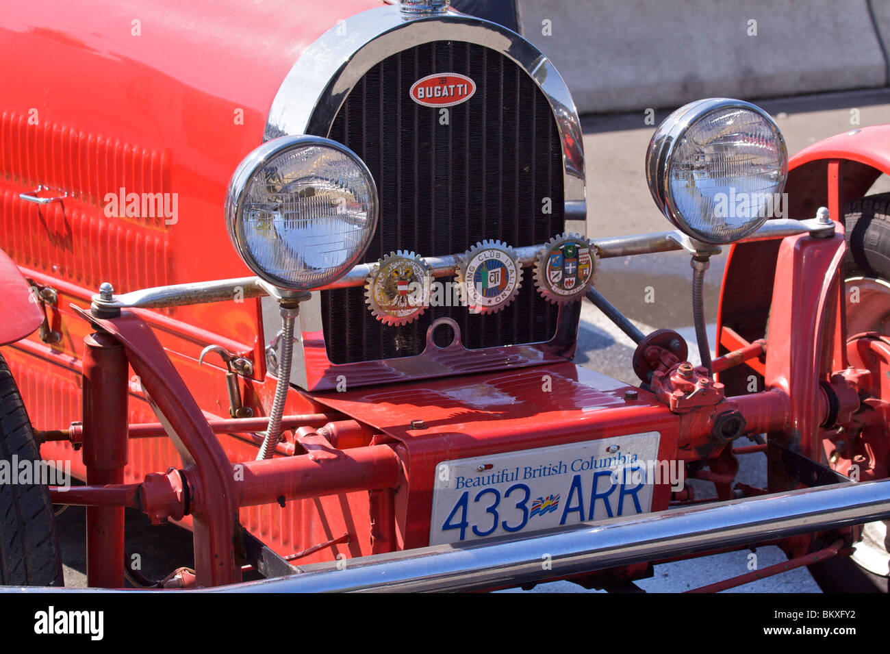 Front of a bright red Bugatti car with chrome metal, badges and BC ...