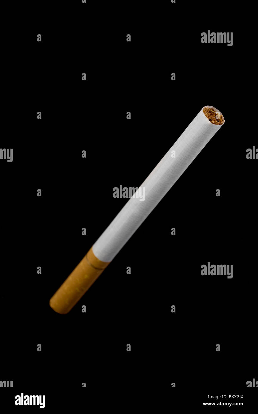 un-smoked cigarette isolated on black Stock Photo - Alamy
