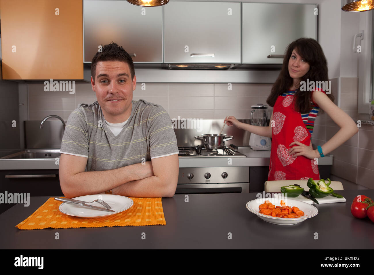 Girl cooking for a hungry guy Stock Photo - Alamy
