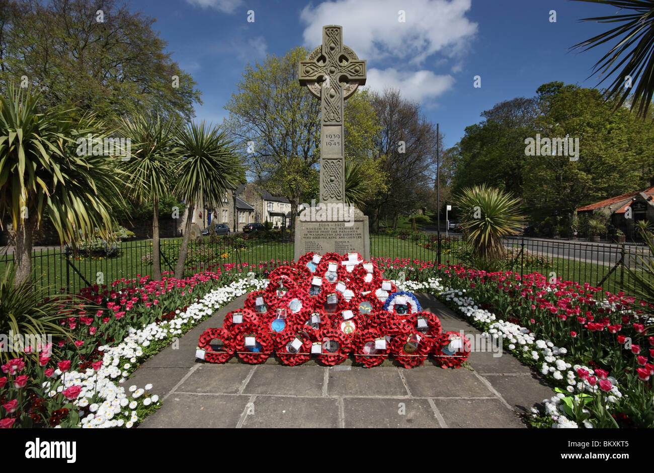 Floral decoration surrounds the war memorial in Washington Village ...