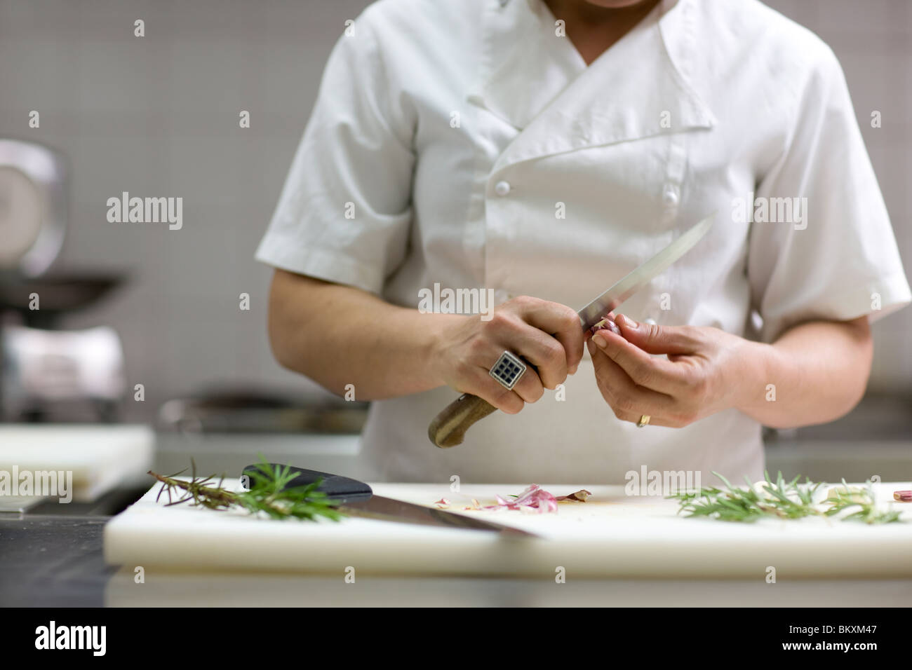 Woman chef peeling garlic knife hi-res stock photography and images - Alamy