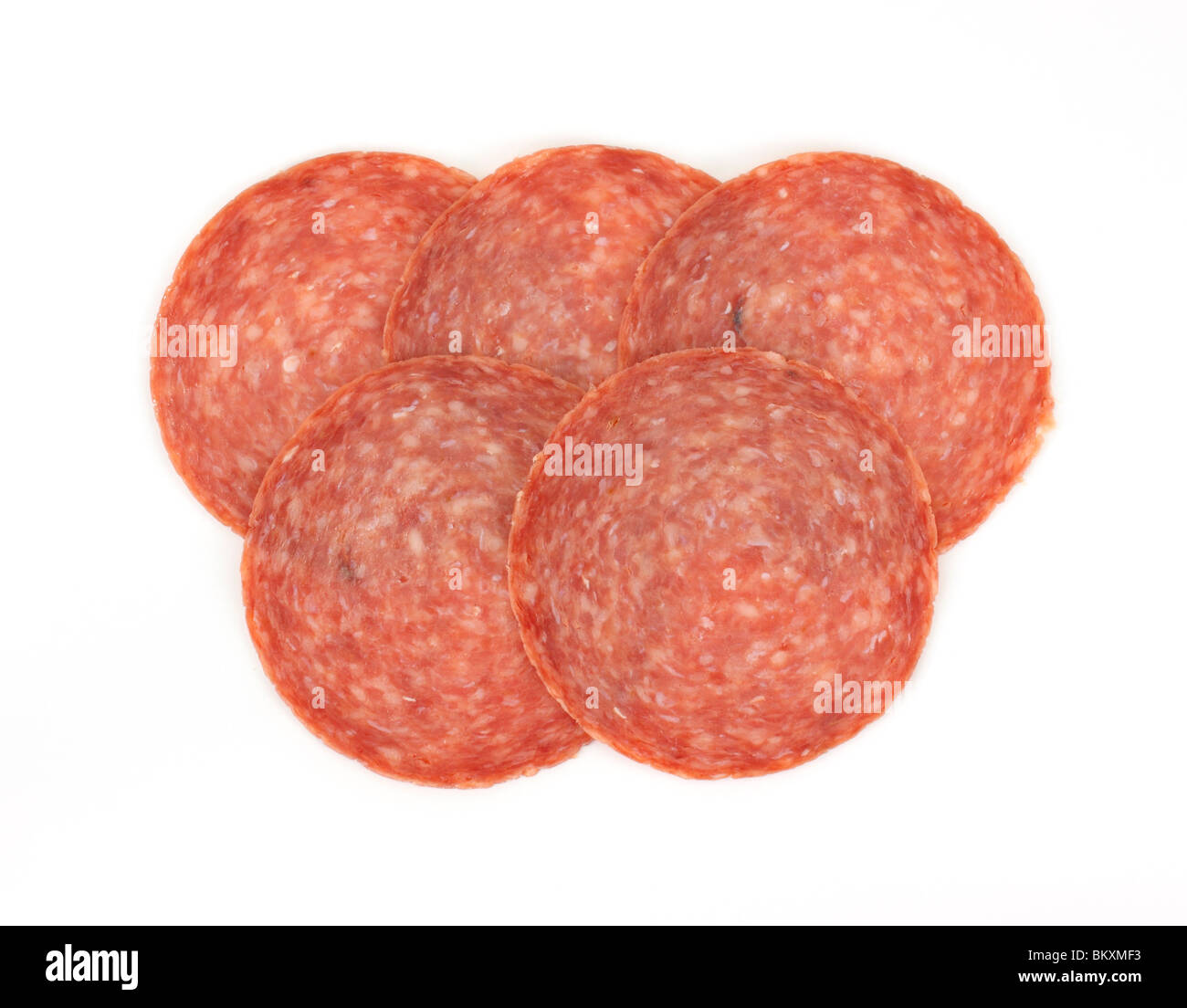 Five slices of hard salami Stock Photo - Alamy