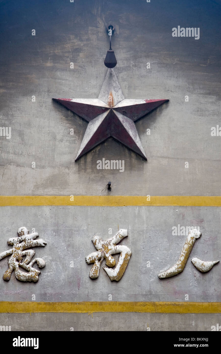 Communist star and saying of Mao Zedong on old administrative building ...