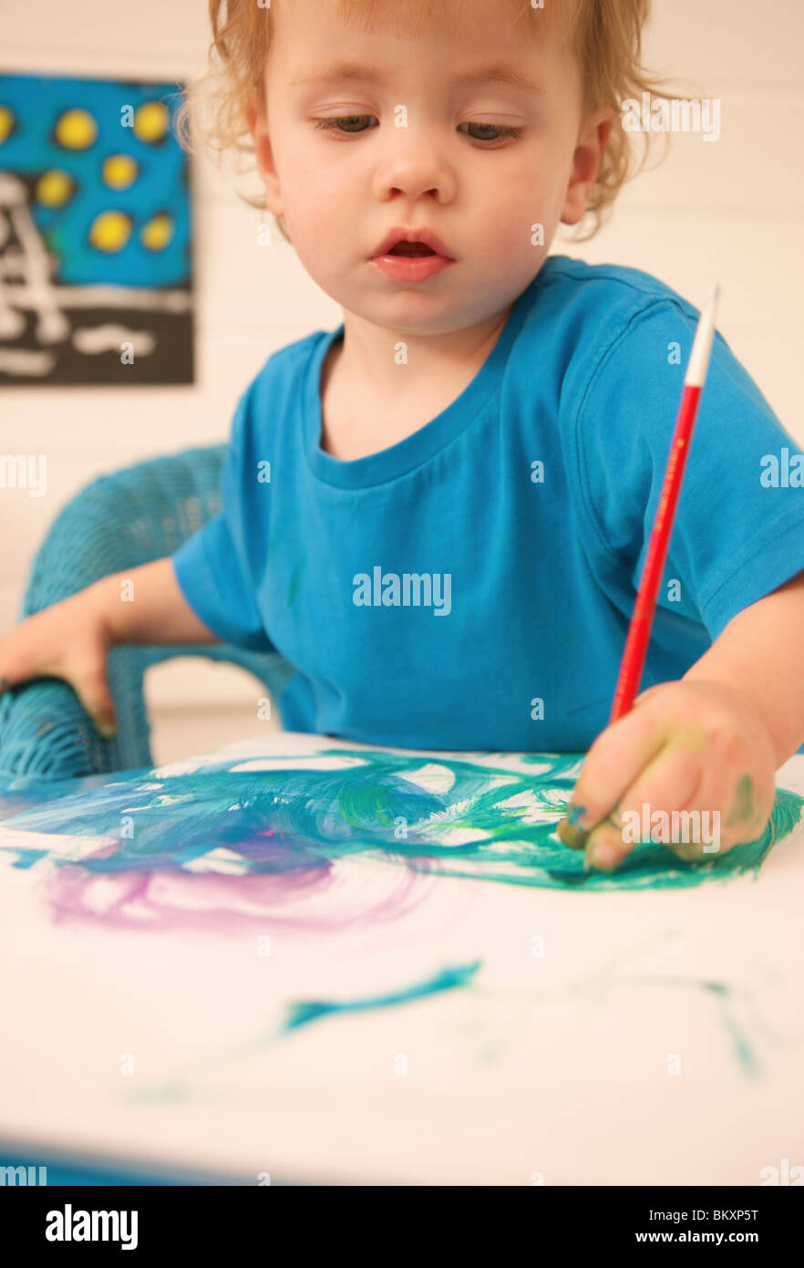 Young boy painting with watercolours Stock Photo - Alamy