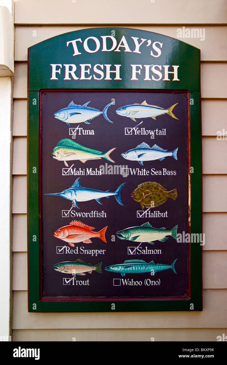 Chalk marks on an illustrated menu board indicate the fresh fish that ...