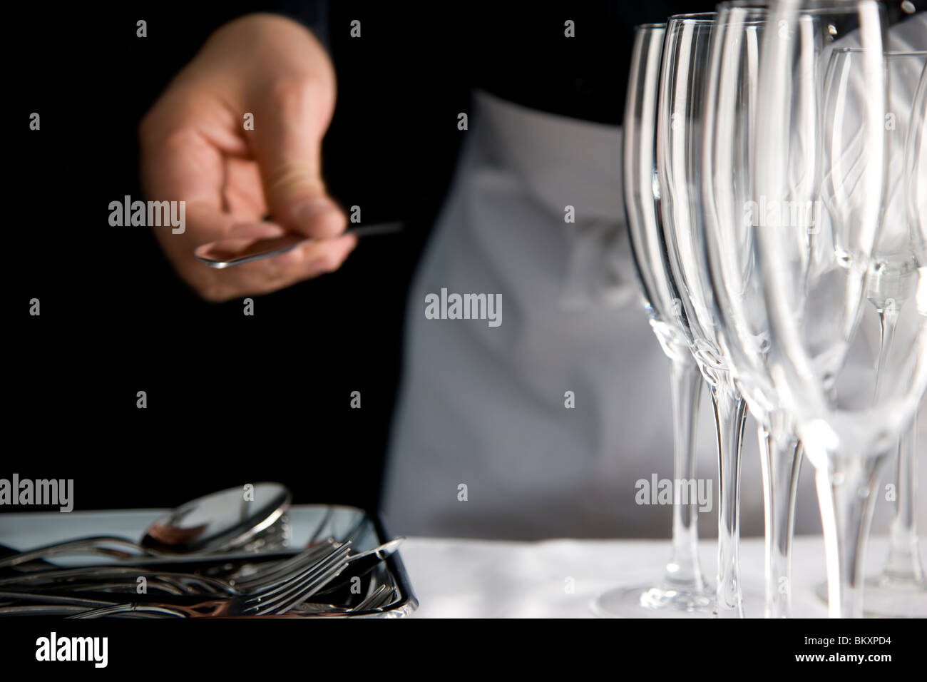 Waiter holding tray and setting table in a fancy restaurant Stock Photo ...