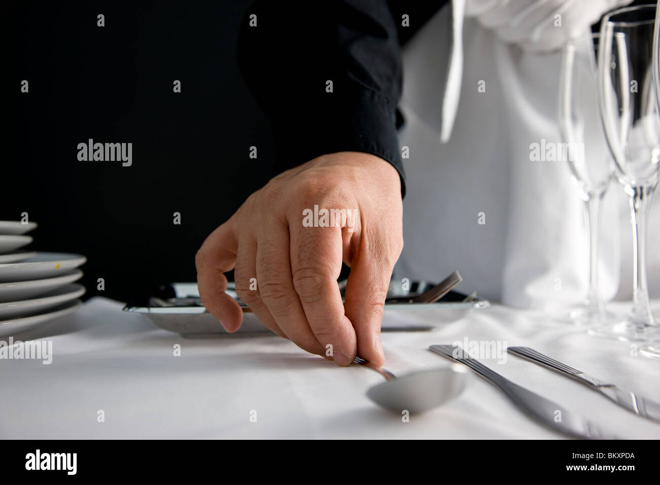 Waiter holding tray and setting table in a fancy restaurant Stock Photo ...