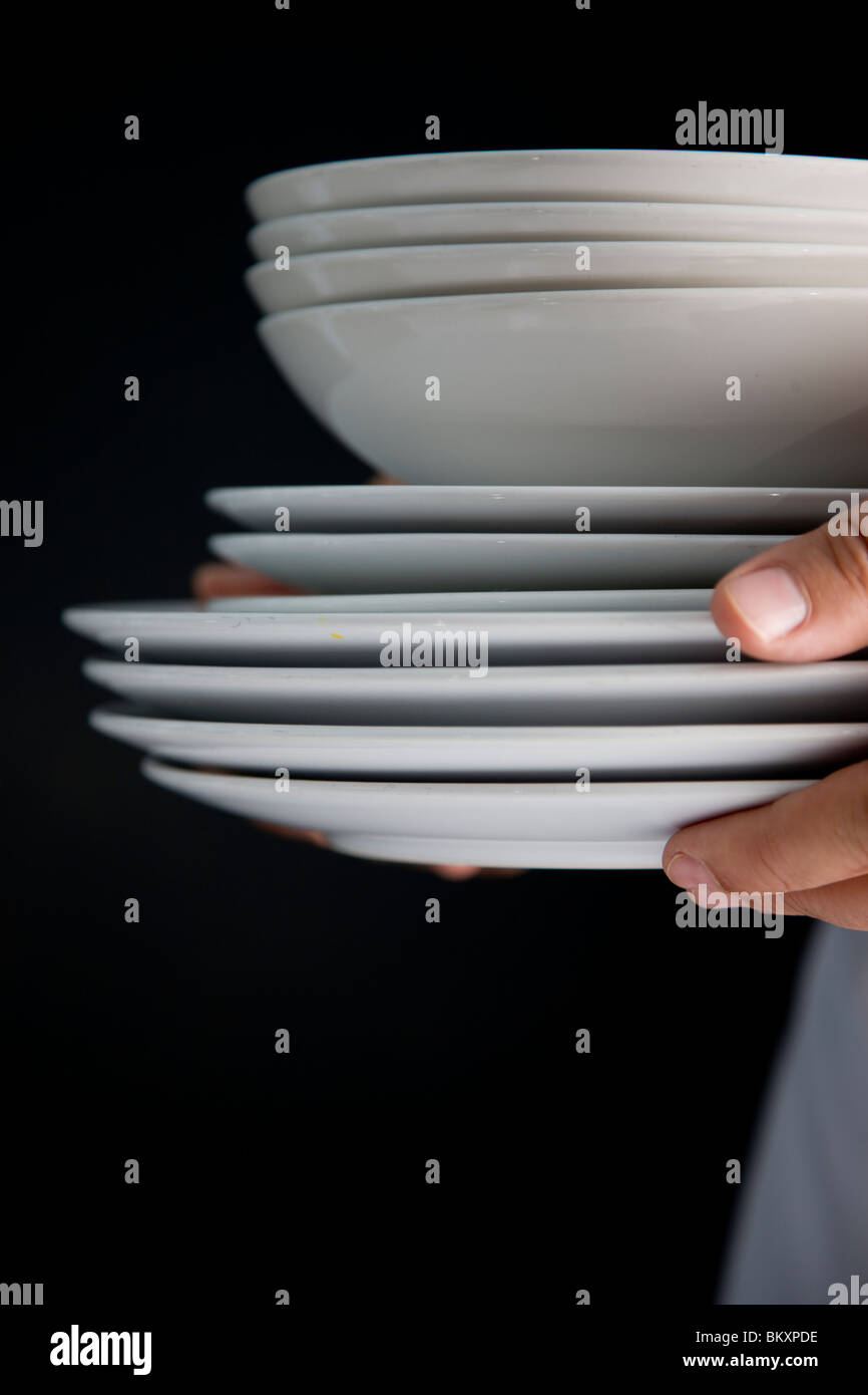 Hands holding stack of plates hi-res stock photography and images - Alamy