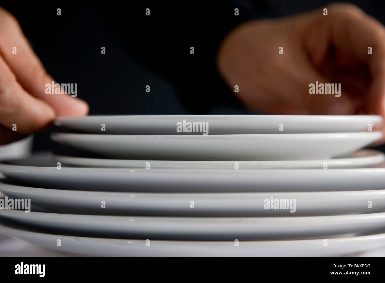 Hands holding stack of plates hi-res stock photography and images - Alamy