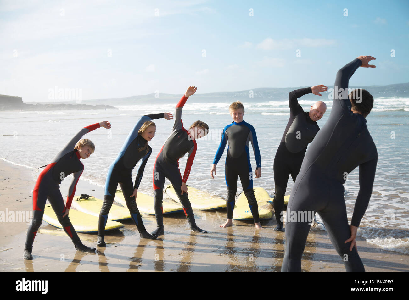 Female surfer stretching at beach hi-res stock photography and images ...