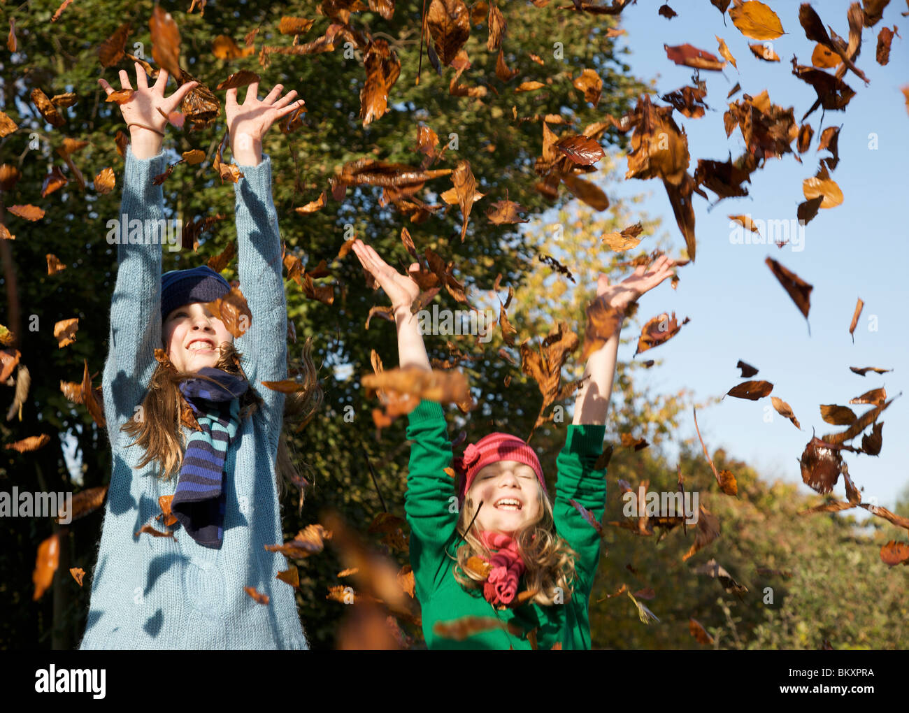 Two girls throwing leaves hi-res stock photography and images - Alamy