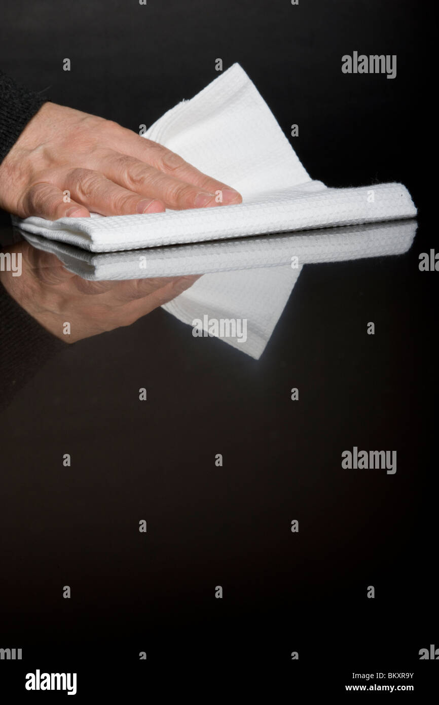 Close up of a man hand dusting with a white cloth Stock Photo - Alamy