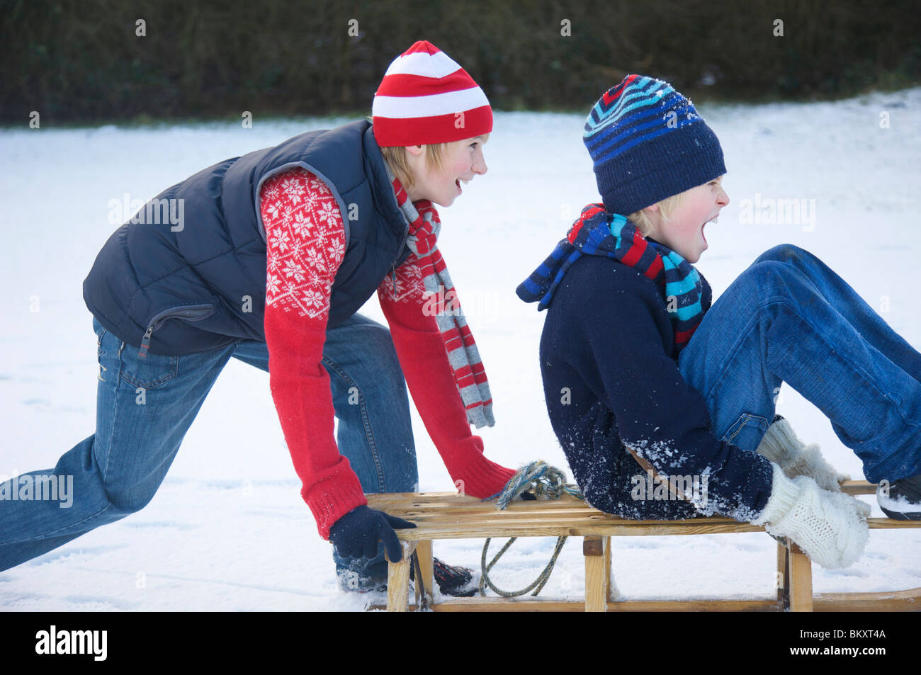 Boy pushing sled hi-res stock photography and images - Alamy