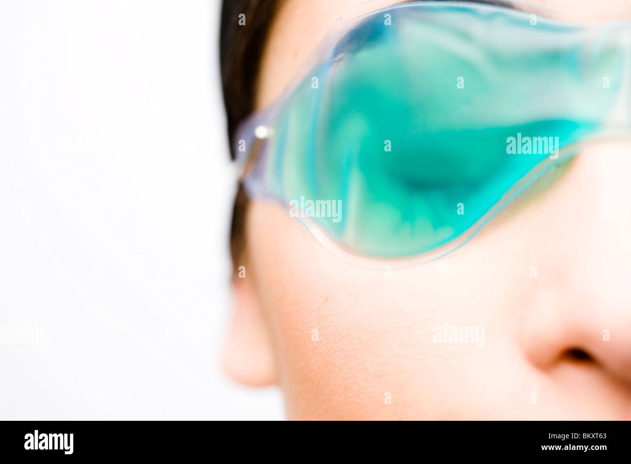 Extreme close up of a woman wearing a cooling eye mask - half face ...