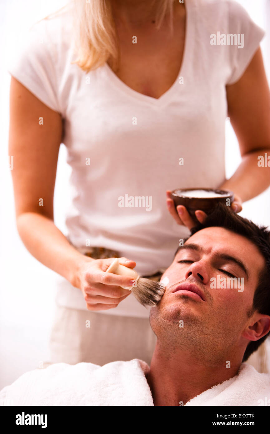 Woman applying shaving cream on man face Stock Photo - Alamy