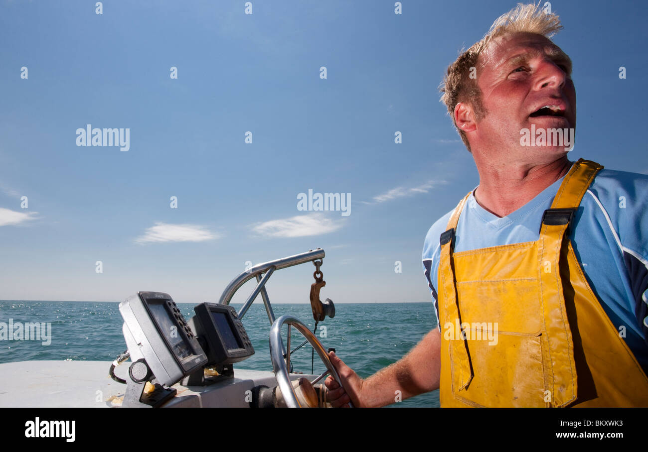 Fisherman driving a boat hi-res stock photography and images - Alamy