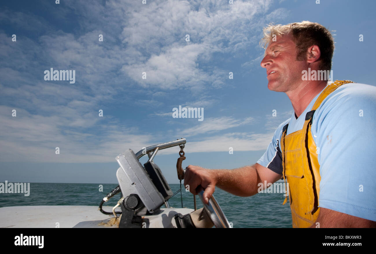 Fisherman driving a boat hi-res stock photography and images - Alamy