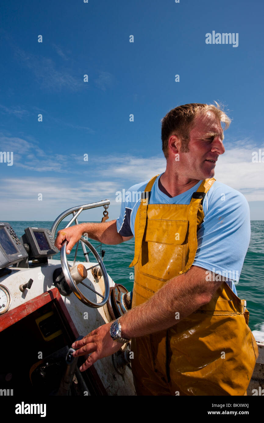Fisherman driving a boat hi-res stock photography and images - Alamy