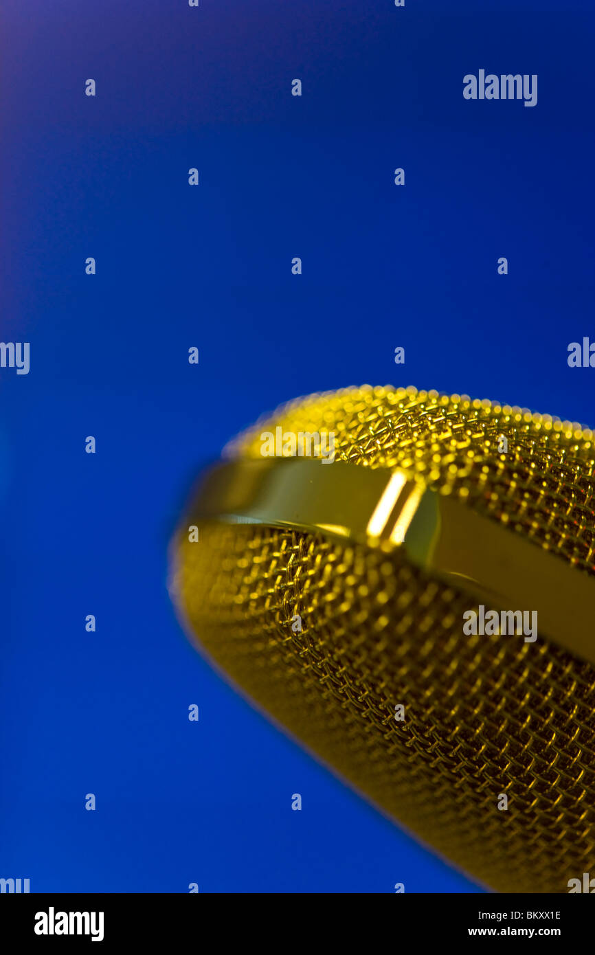 Extreme close up of a gold microphone Stock Photo - Alamy
