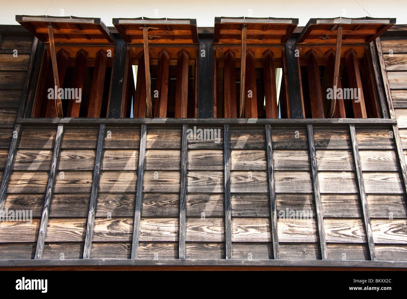 Defensive firing windows in timber and plaster wall at Matsuyama castle ...