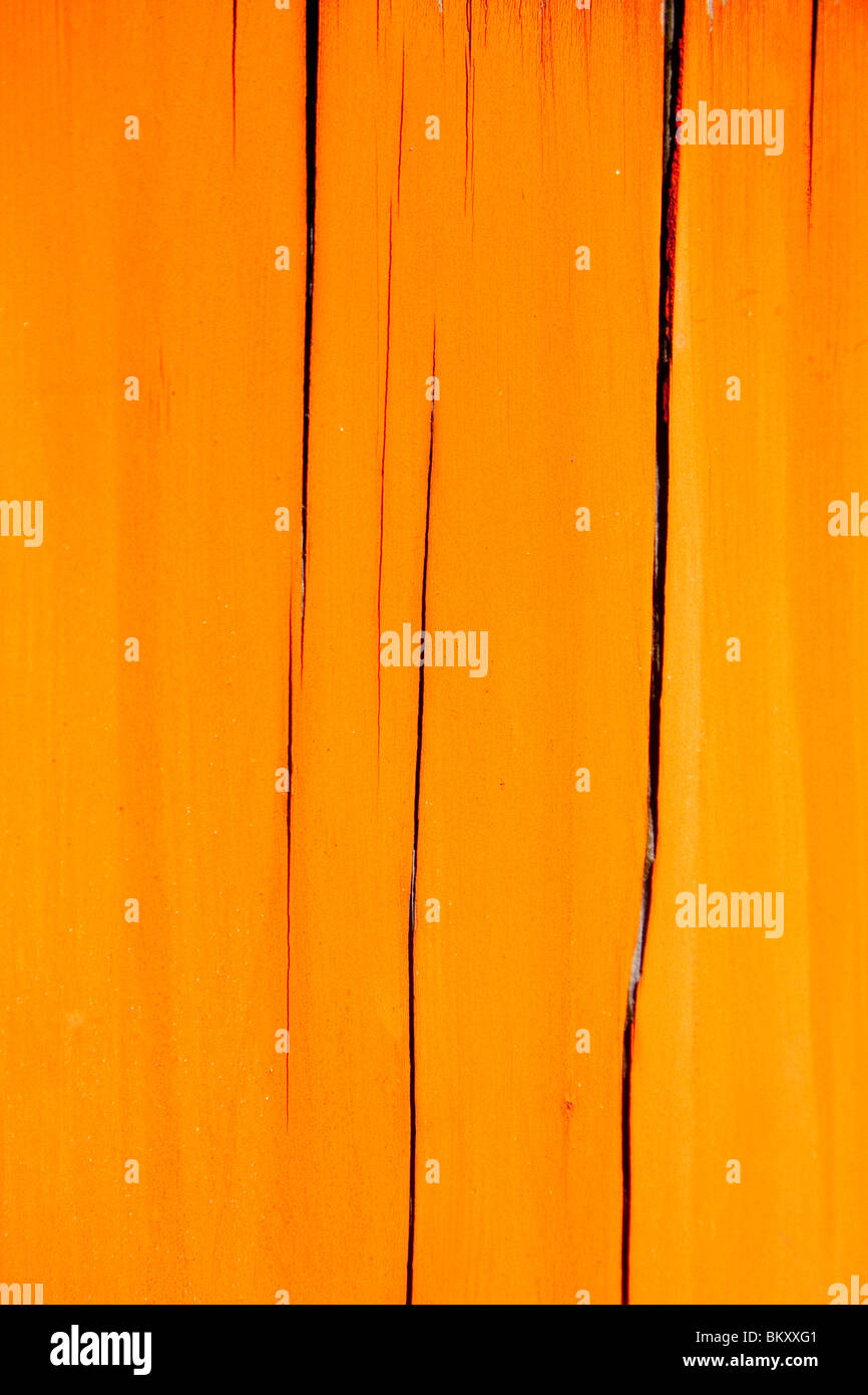 Close up detail of orange vermilion paint on a weathered part of a ...