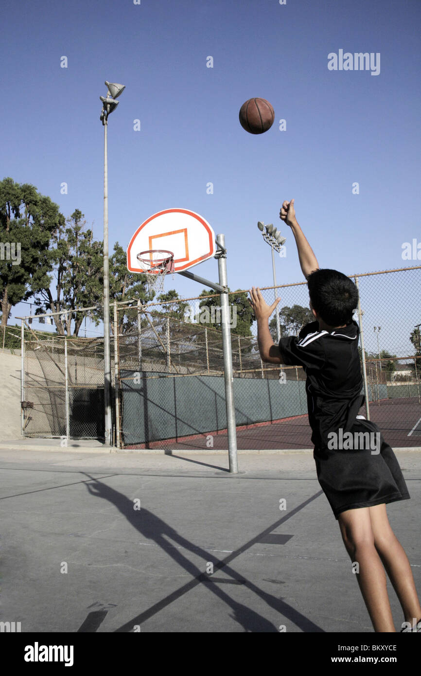 Boy playing basketball Stock Photo - Alamy
