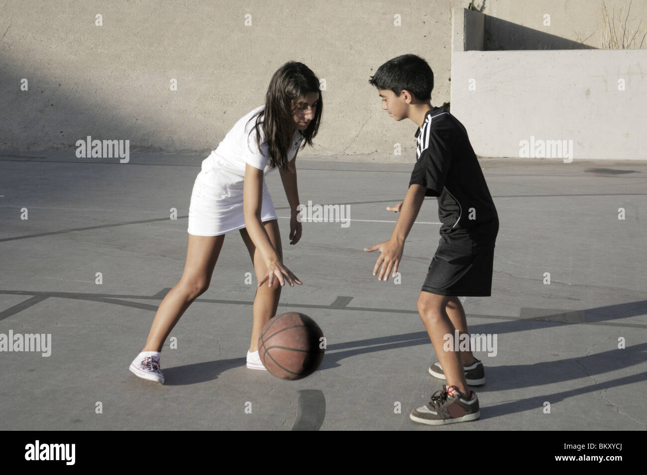 Two children playing basketball Stock Photo - Alamy