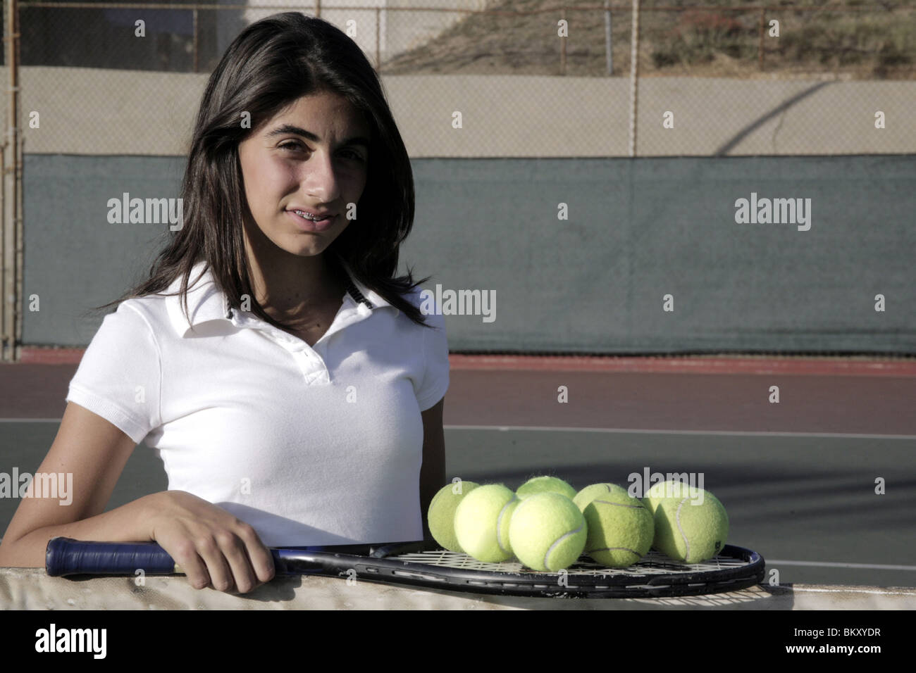 Girl balancing tennis balls on her racquet Stock Photo - Alamy
