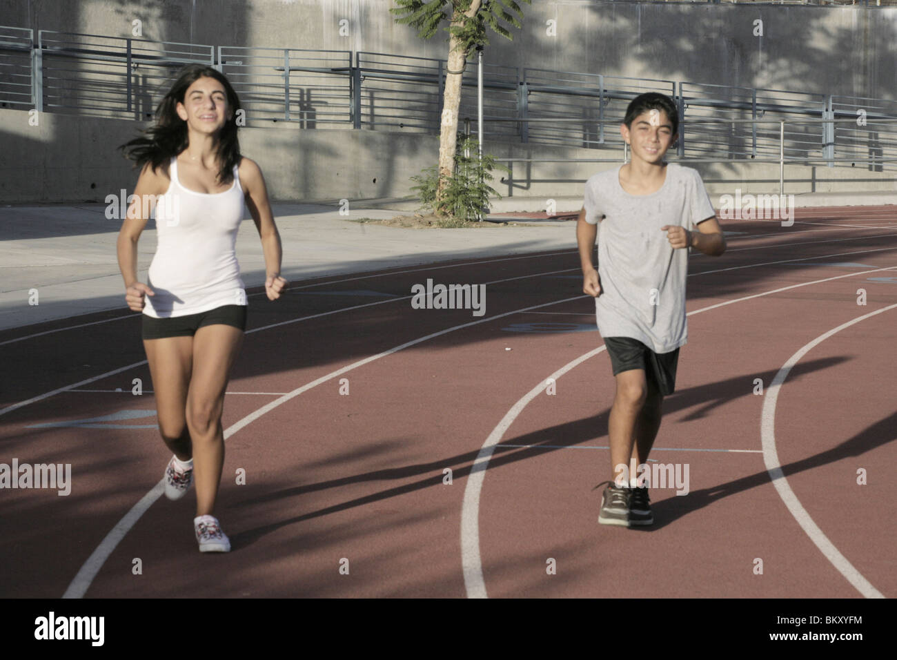 Two children on a running track Stock Photo - Alamy