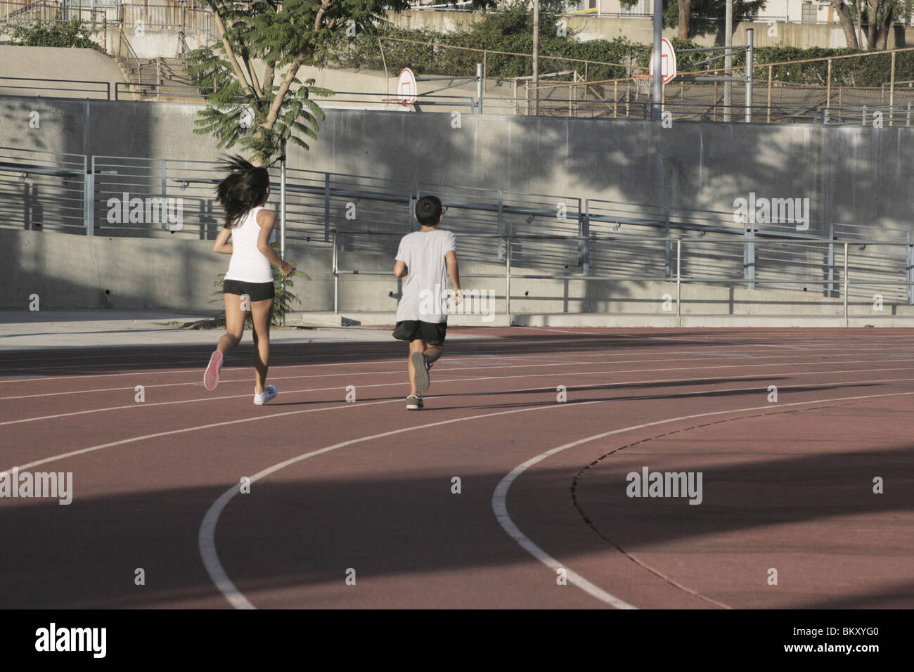 Two children on a running track Stock Photo - Alamy