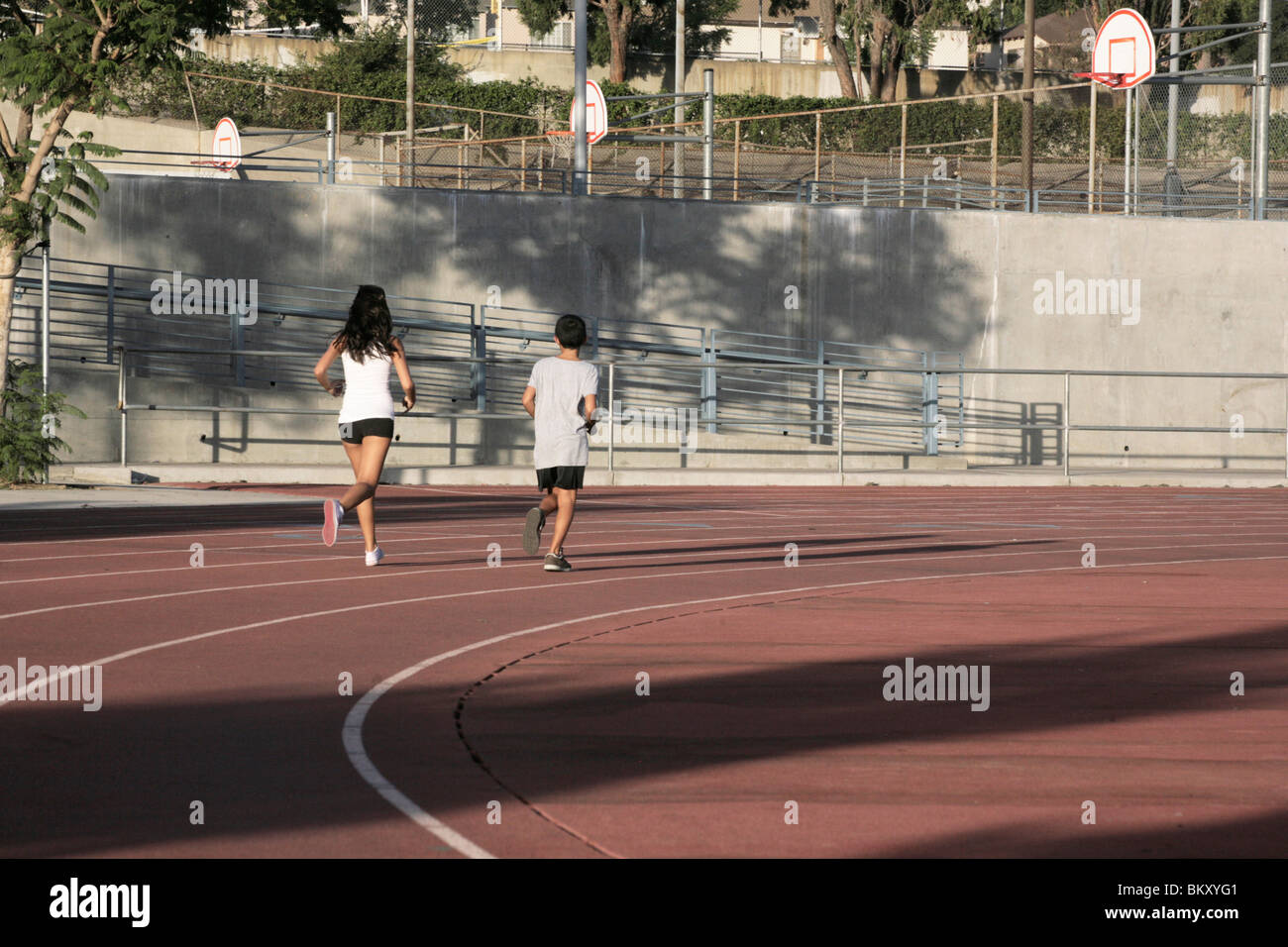 Two children on a running track Stock Photo - Alamy