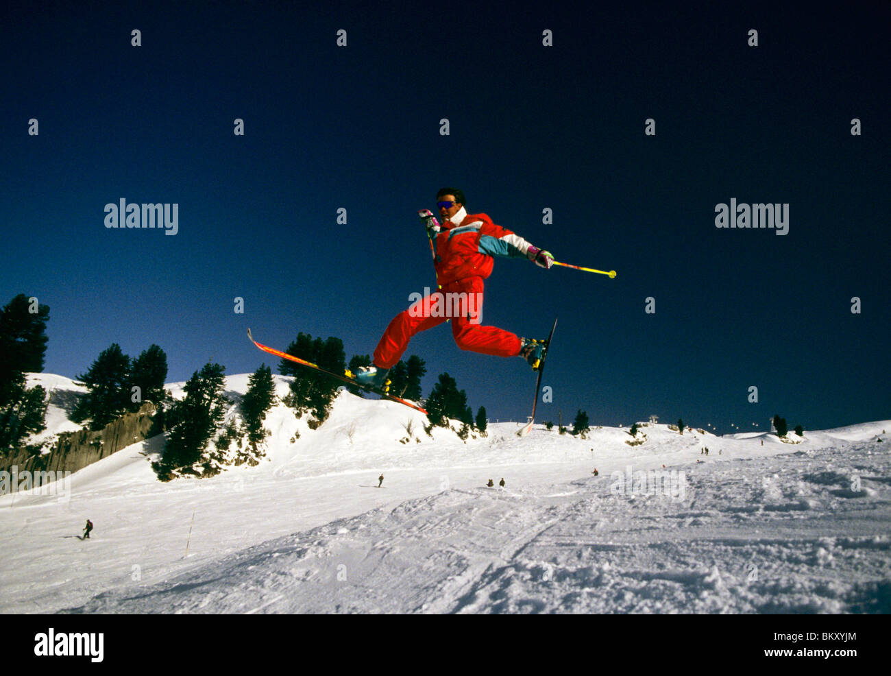 Man jumping midair while skiing Stock Photo - Alamy