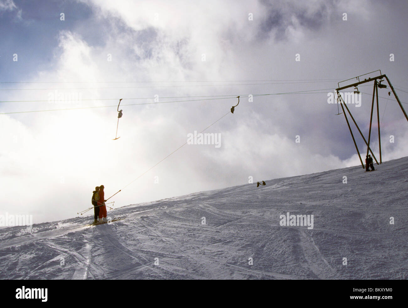 People being taken up slope by a ski tug Stock Photo - Alamy
