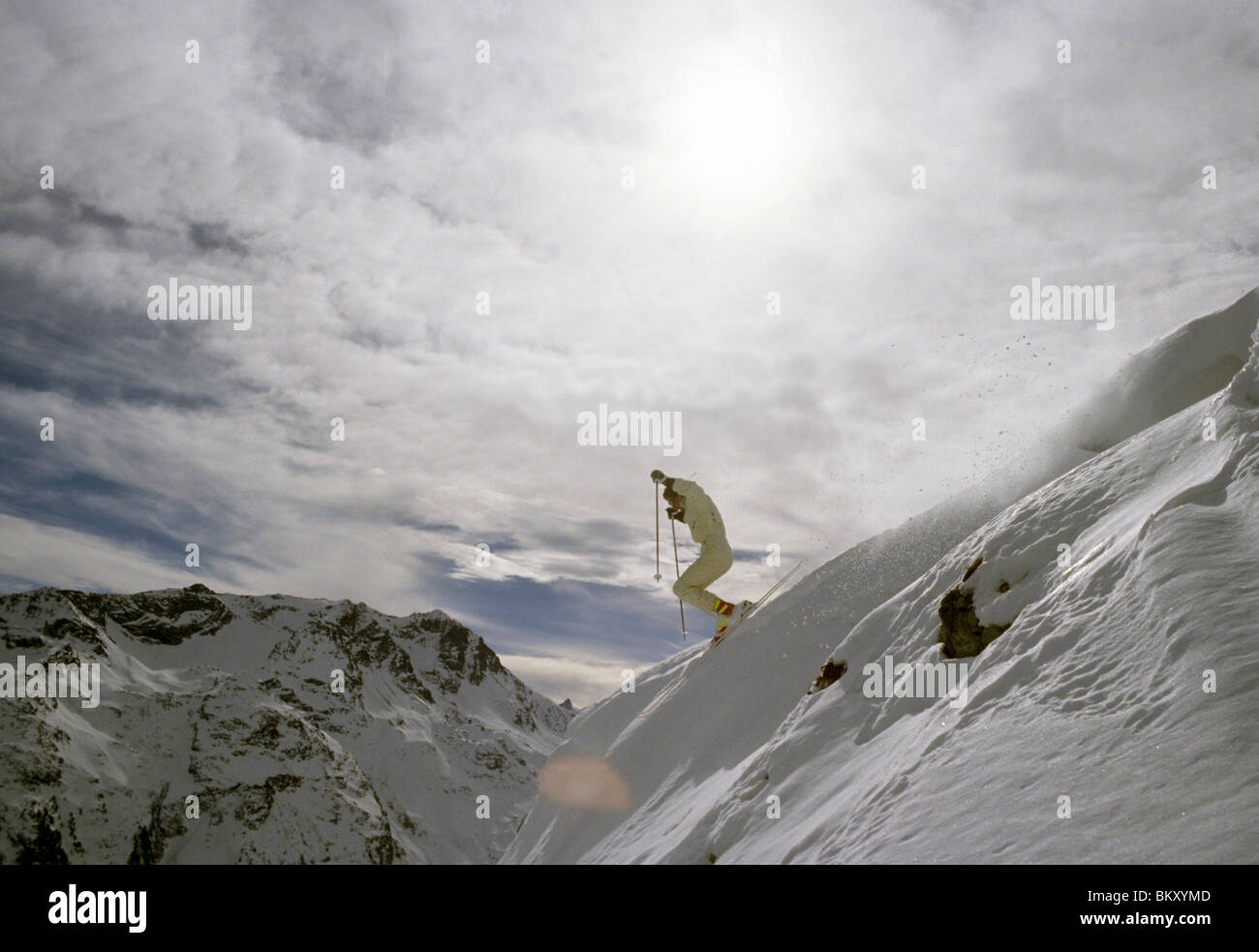 Man jumping off edge of slope while skiing Stock Photo - Alamy