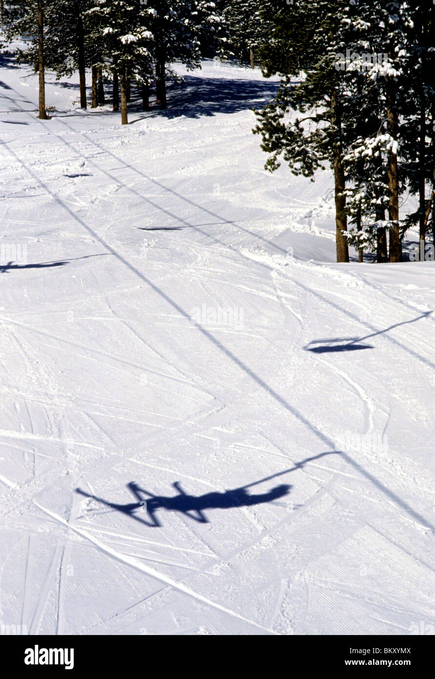 Shadow in snow of people on ski lift Stock Photo - Alamy