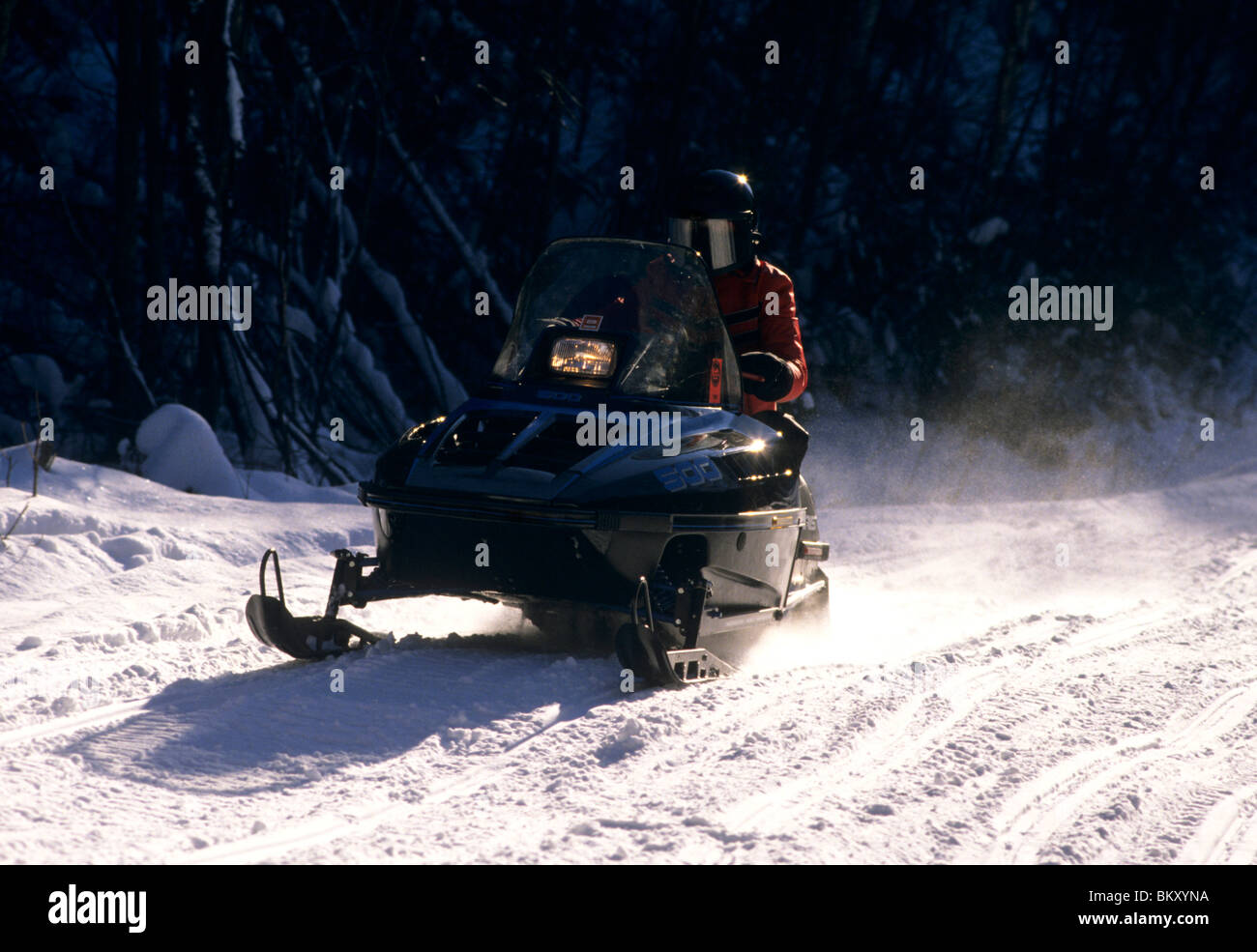 Man riding snow mobile Stock Photo - Alamy