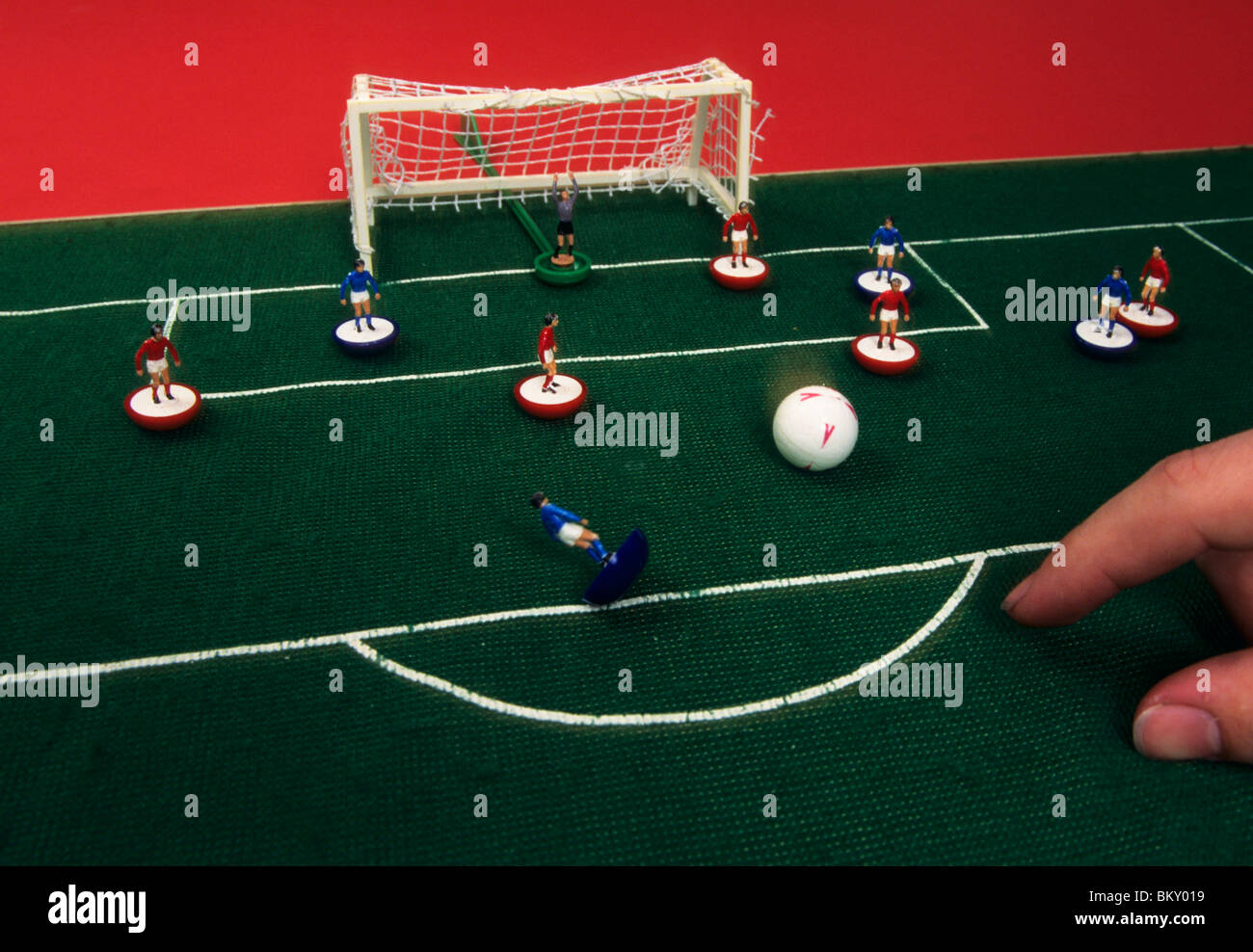 Person playing subbuteo table football Stock Photo - Alamy