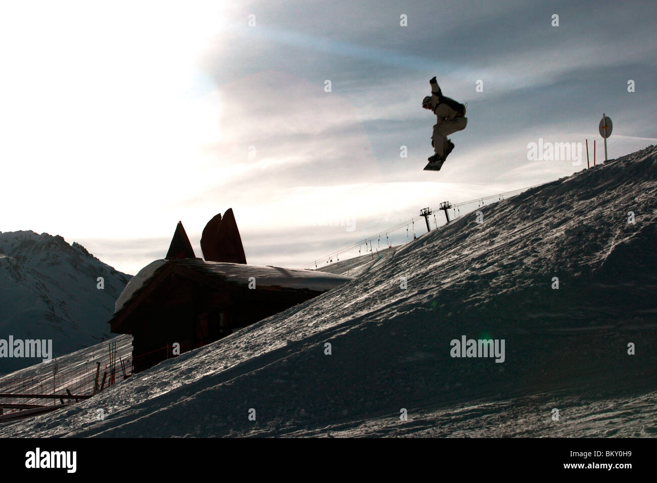 Person doing jump while snowboarding Stock Photo - Alamy