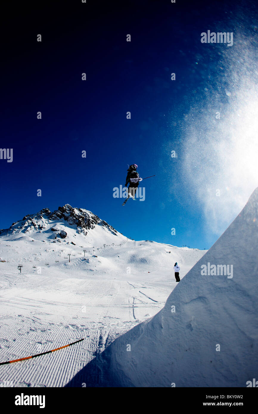 Man jumping over crest of hillside while skiing Stock Photo - Alamy