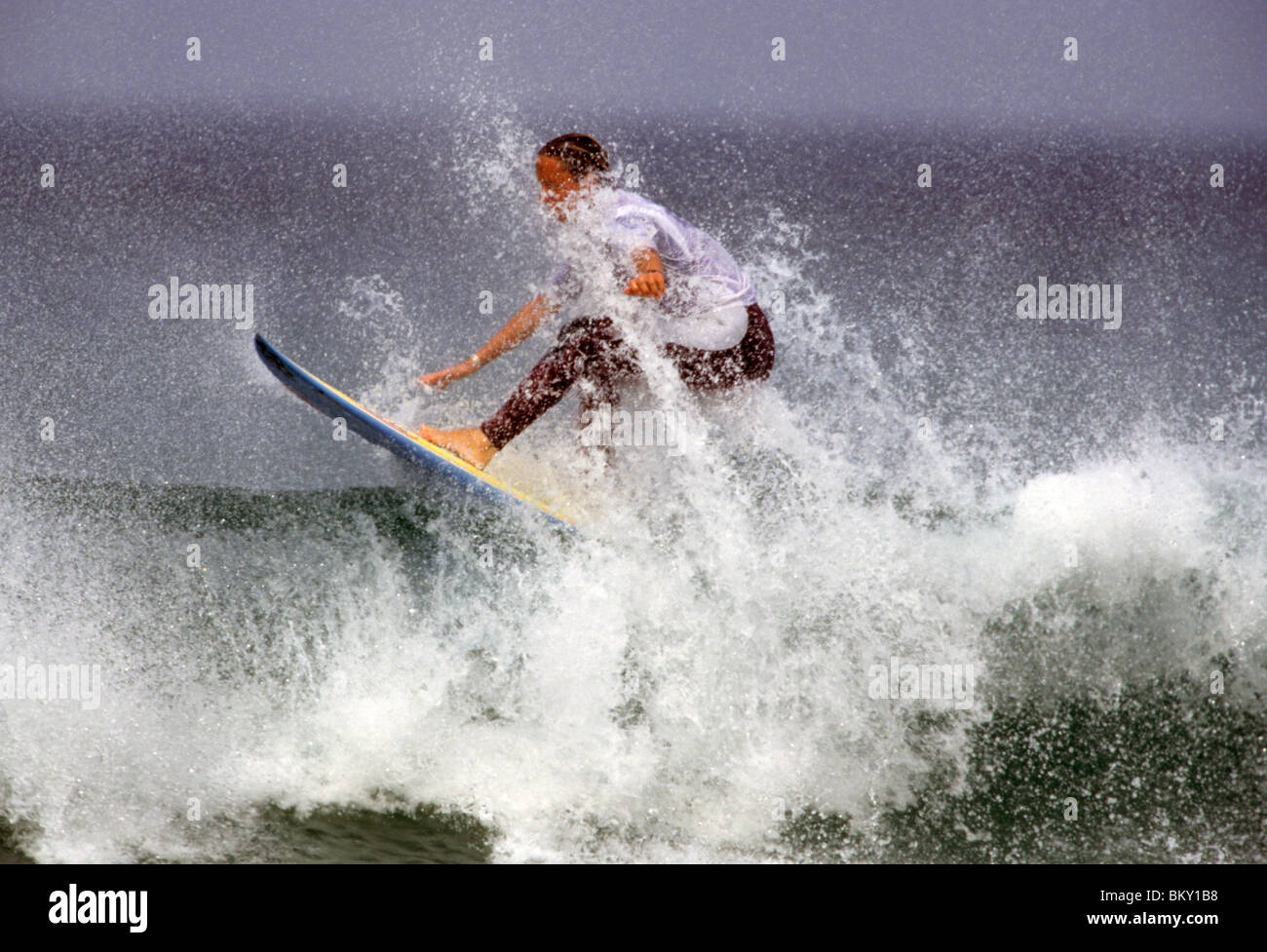 Man surfing crashing wave near beach Stock Photo - Alamy